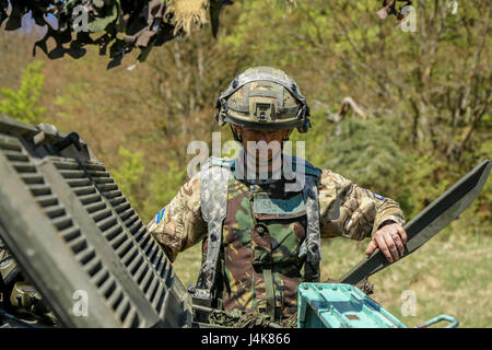 A British soldier performs pre-combat checks on an FV107 Scimitar ...