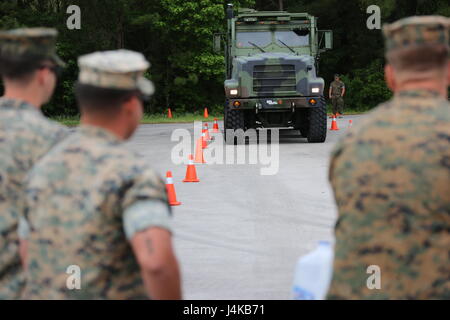 Marine transport operators observe a fellow student operating a M970 ...