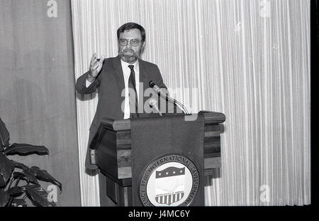 A military official addresses an audience from a podium, providing ...