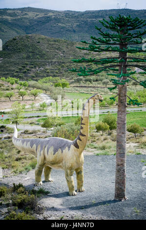 Replica of sauropod camarasaurus eating leafs of araucaria conifer tree ...
