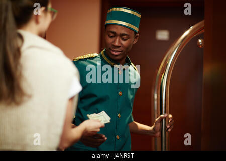 Man in hotel room with bellboy Stock Photo - Alamy