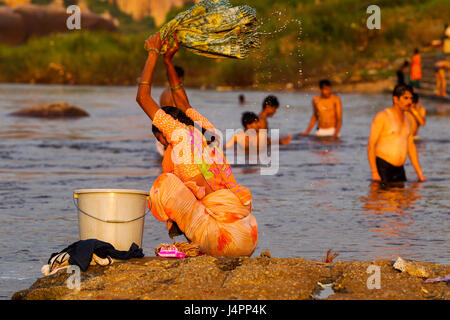 Indian woman washing clothes at Tungabhadra River, Hampi, Karnataka ...