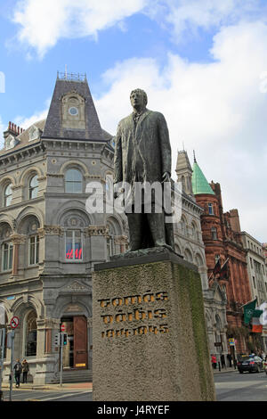 Ireland, Dublin, young man at city dock listening to music Stock Photo ...