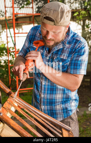 old man drilling wood furniture at home Stock Photo - Alamy