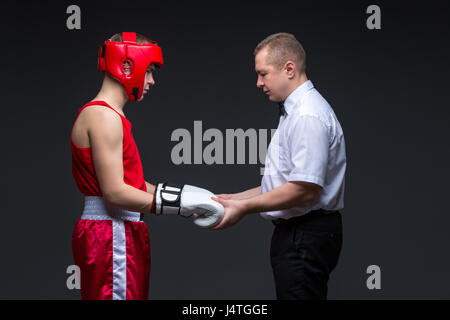 Referee checking young boxer Stock Photo - Alamy