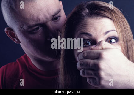 Woman being strangled by male hand in a scene of domestic violence ...