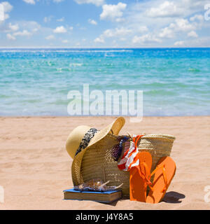 sunbathing accessories on sandy beach Stock Photo - Alamy