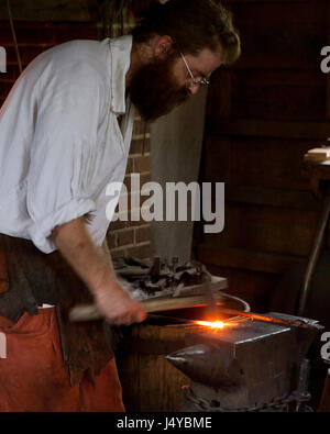 18th century blacksmith reenactor working in blacksmith shop - USA ...