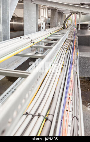 Electrical cables are located in a cableway on the roof of a building ...