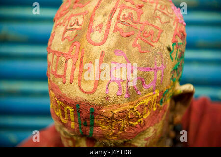 Priest writing radhe krishna on face by sandalwood paste, uttar pradesh ...