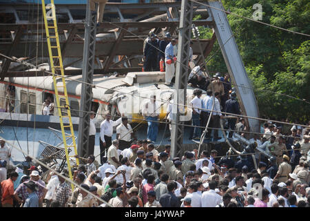 People gather during water pipeline collapsed over moving train, thane ...