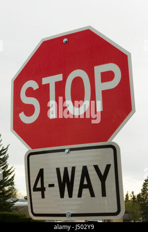 4 way Four way stop sign at intersection, residential neighborhood ...