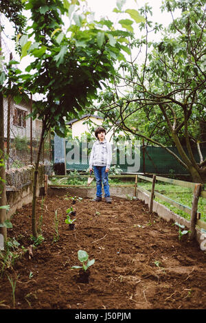 child preparing vegetable garden Stock Photo - Alamy