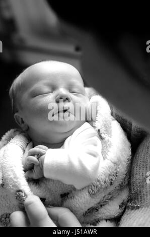 Mother watching over sleeping baby on bed Stock Photo - Alamy