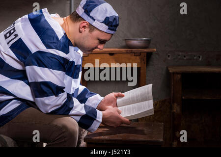 Male prisoner reading in his cell, HMP Winchester, Winchester ...