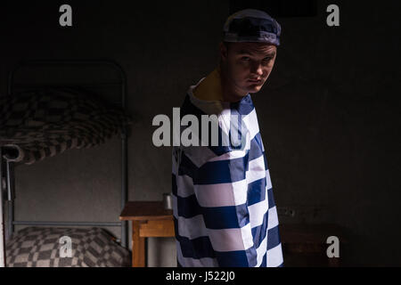 Angry prison inmate in dark room Stock Photo - Alamy