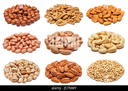 pecans, hazelnuts, almonds, pine nuts, cashews in wooden bowls on blue ...