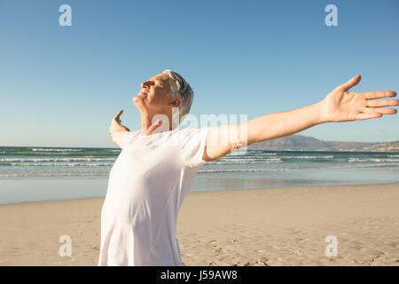 Senior man with arms outstretched standing against clear sky Stock ...