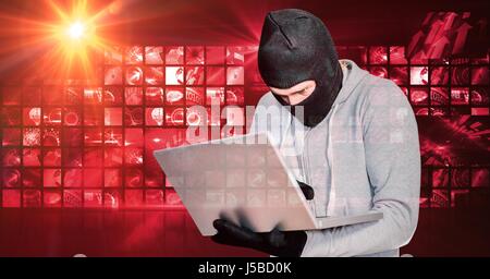Digital composite of Hacker wearing monkey cap while using laptop Stock ...