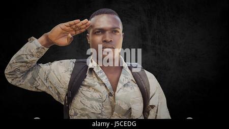 Digital composite of Soldier with backpack saluting against black ...