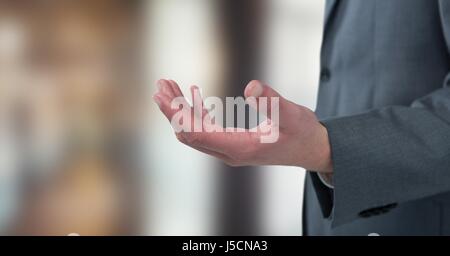 Midsection of young contemporary businessman in blue shirt spraying ...