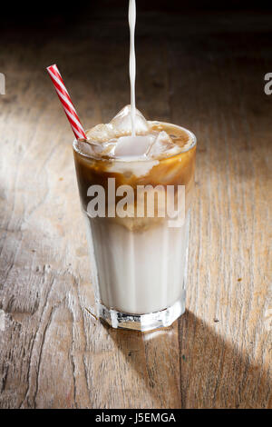 Ice cold coffee on a wooden table Stock Photo - Alamy