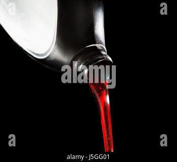 Pouring motor oil from red container isolated on white Stock Photo - Alamy