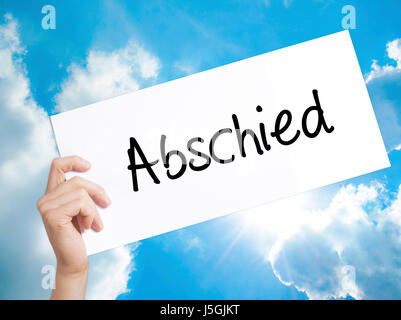 Abschied (Farewell in German) Sign on white paper. Man Hand Holding ...