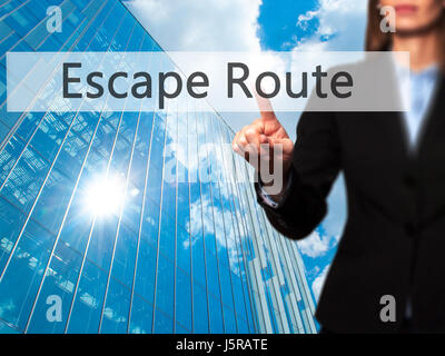 Escape Route - Hand pressing a button on blurred background concept ...