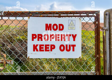 Ministry of Defence fence and keep out warning sign on steep South West ...