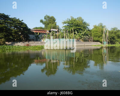 This photograph showcases the riverbanks of Pulilan in Bulacan ...