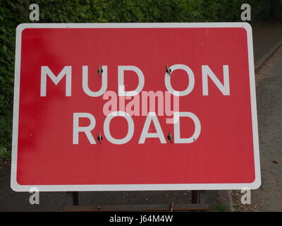 'Caution Mud on Road' sign on an empty Norfolk country lane Stock Photo ...