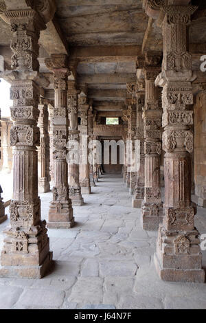 Columns with stone carving in courtyard of Quwwat-Ul-Islam mosque, Qutub Minar complex, Delhi ...