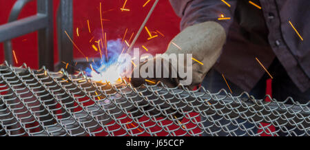 operator is welding a net with flash light and smoke Stock Photo - Alamy