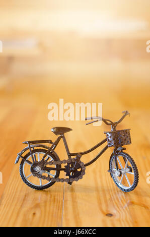 Small toy, bicycle model on wooden background Stock Photo - Alamy