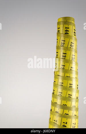 Rolled old yellow tape measure Stock Photo - Alamy
