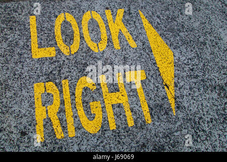 "Look Right" sign painted on the street in English and Chinese Stock ...