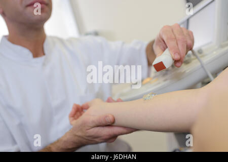 doctor performing ultrasound on arm Stock Photo - Alamy
