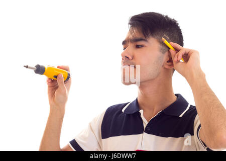 Handsome young man holding screwdriver wearing hardhat smiling with an ...