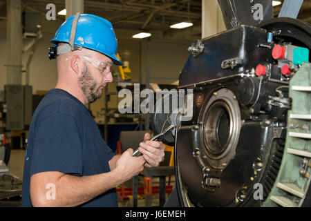 A jet engine mechanic at the AFRC T-56 Centralized Repair Facility ...