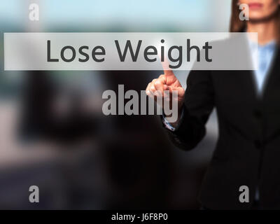Lose Weight - Businesswoman hand pressing button on touch screen ...