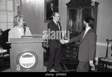 MAN GREETING ANOTHER MAN WITH A WOMEN AT THE PODIUM Stock Photo - Alamy