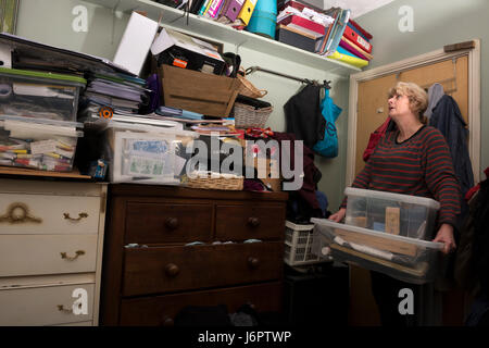 Woman in her bedroom which is full of clutter Stock Photo - Alamy