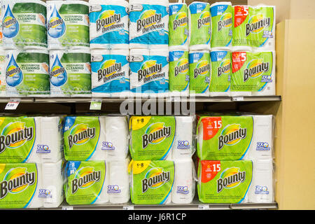 packages of Bounty brand paper towels stacked on grocery store shelves ...