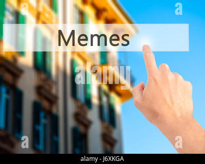 Memes - Hand pressing a button on blurred background concept . Business ...