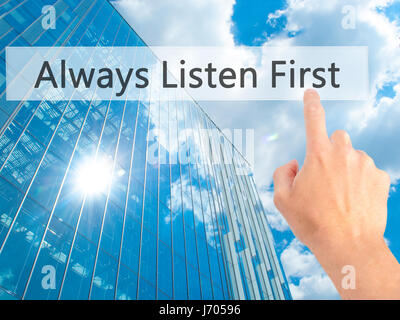 Always Listen First - Hand pressing a button on blurred background ...