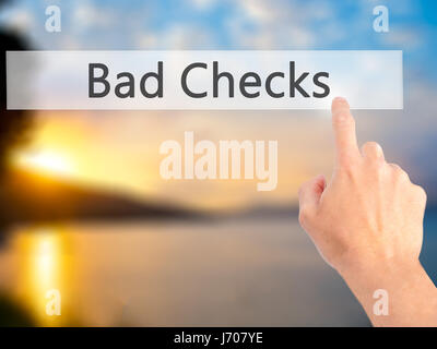 Bad Checks - Hand pressing a button on blurred background concept ...