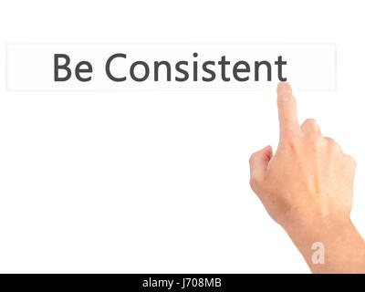 Be Consistent - Hand pressing a button on blurred background concept ...