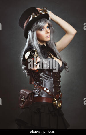 Portrait of steampunk woman with gun. Mechanical background Stock Photo ...