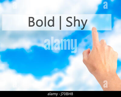 Bold Shy - Hand pressing a button on blurred background concept ...